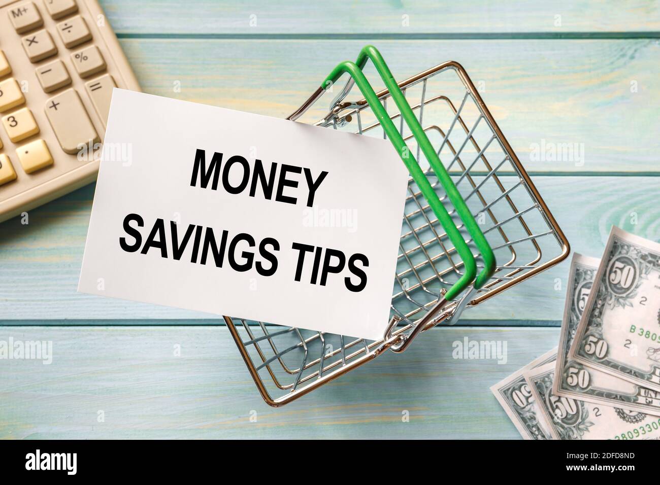 Shopping basket and text MONEY SAVINGS TIPS on white paper note list ...