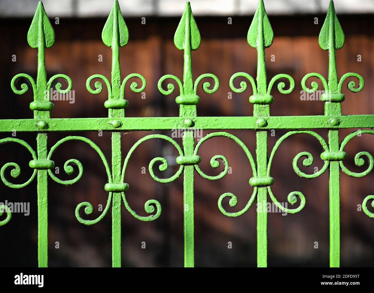 Green metal fence of a garden Stock Photo - Alamy