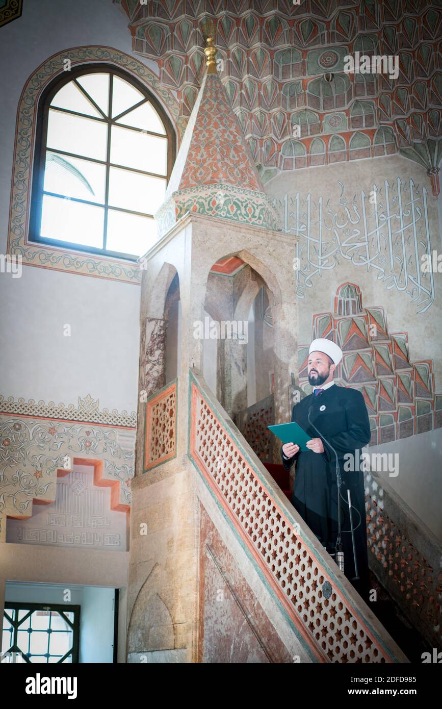 Emam in mosque with Arabic verses from Kuran on the wall Stock Photo ...
