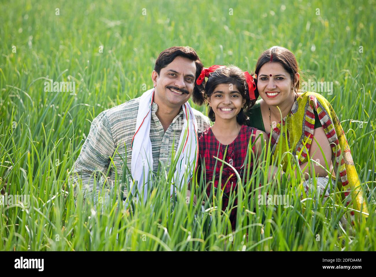 Happy Indian family in agricultural field Stock Photo - Alamy
