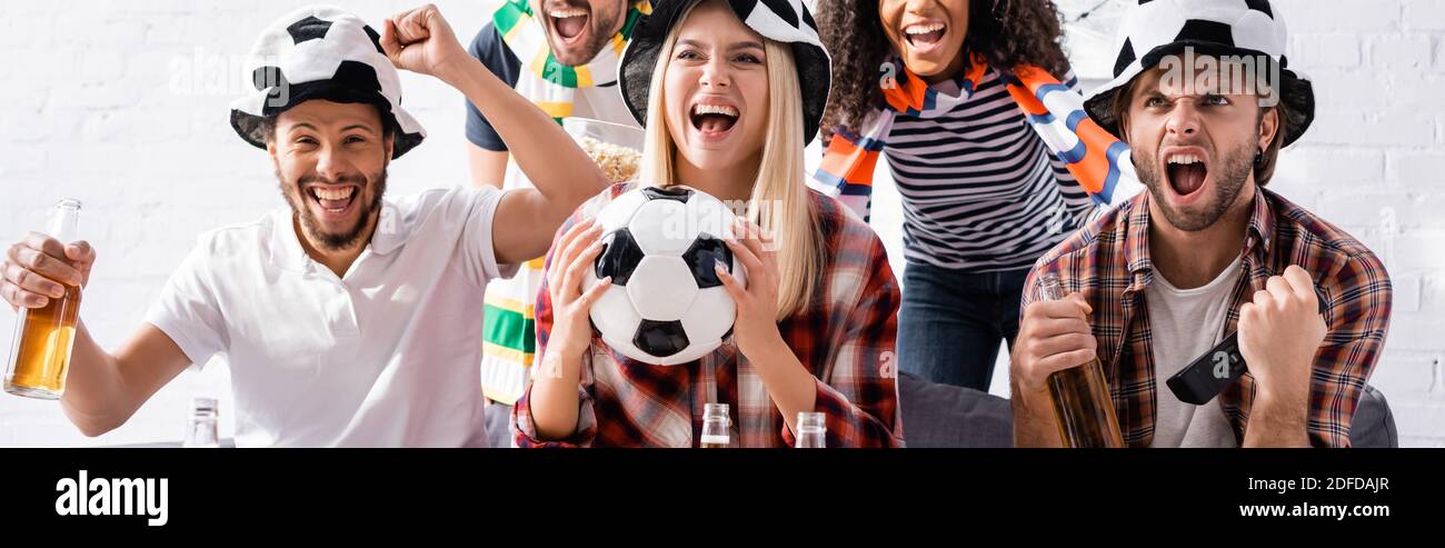 excited multicultural football fans screaming and showing winner ...