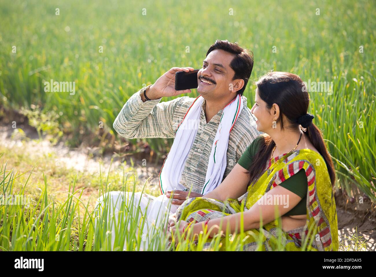 Indian couple farmers using mobile phone in agricultural field Stock ...