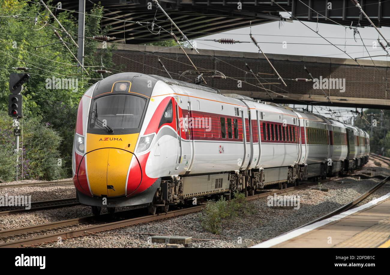 Azuma high speed train in LNER livery speeding through a railway ...
