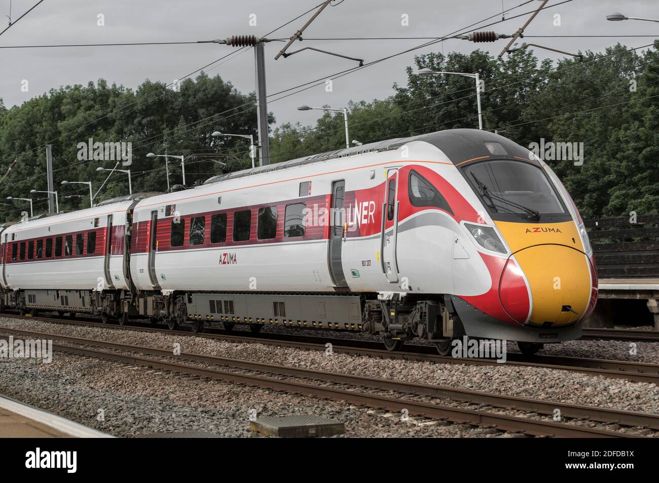 Azuma high speed train in LNER livery speeding through a railway ...