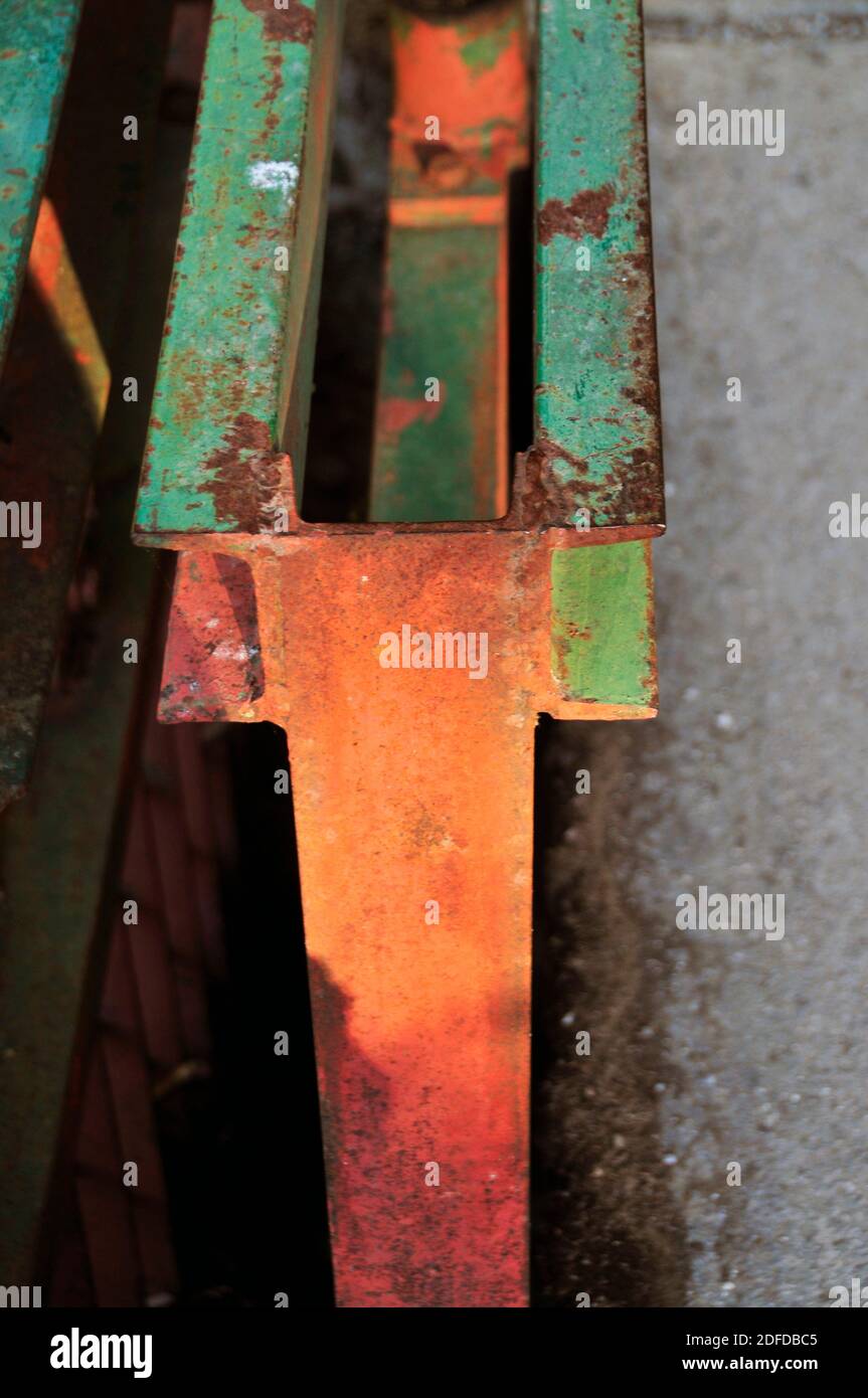 Abstract detail of a rusty beam, with its original green colour fading ...