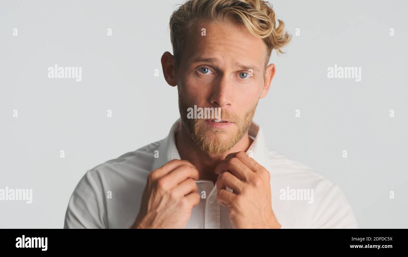 Handsome stylish bearded businessman in shirt preening on camera ...
