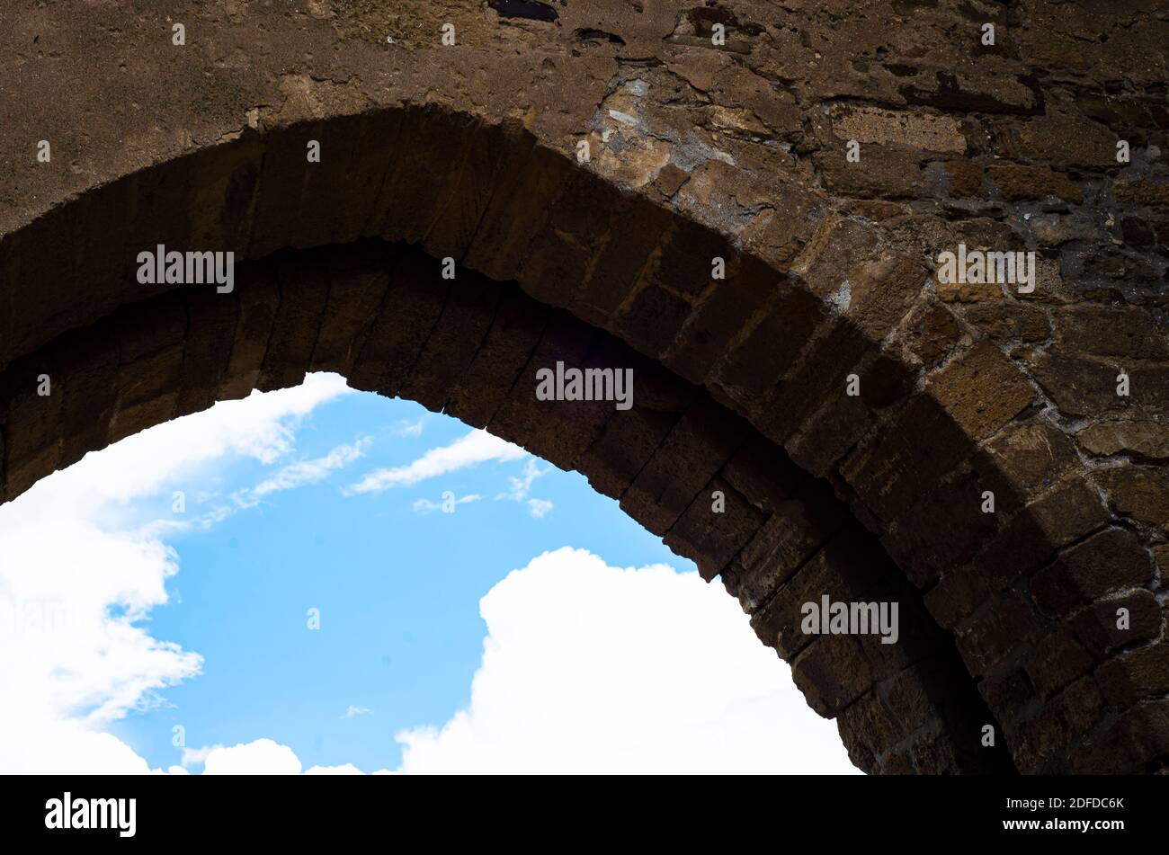 Vaulted arch made of ancient brick and blue sky in the arch. Arches of ...