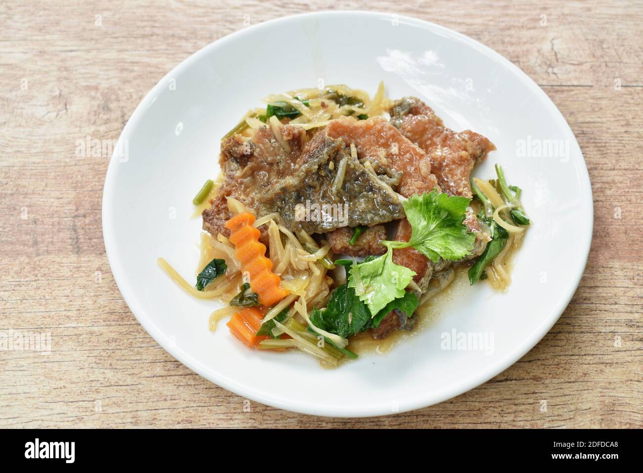 deep fried chop fish with slice ginger and celery on plate Stock Photo ...
