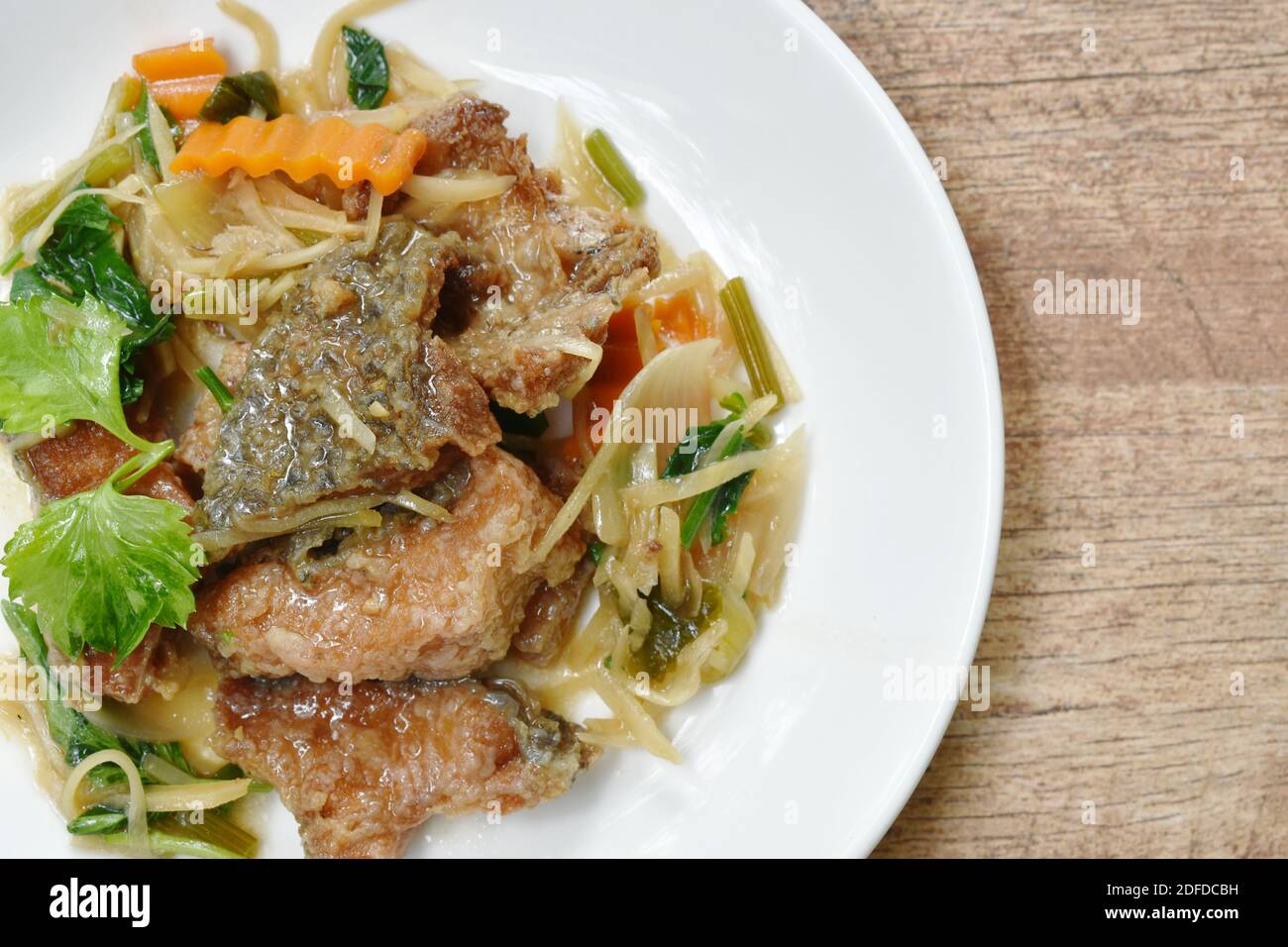deep fried chop fish with slice ginger and celery on plate Stock Photo ...