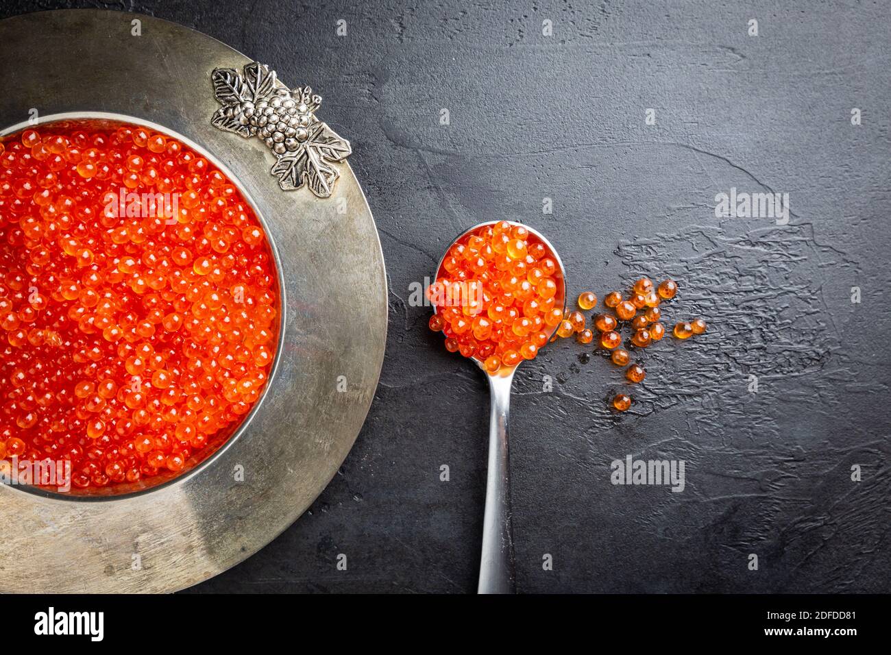 Delicious red caviar in vintage plate, top view, dark background Stock ...