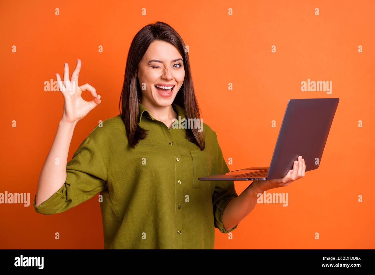 Photo portrait of young female entrepreneur using computer showing okay ...