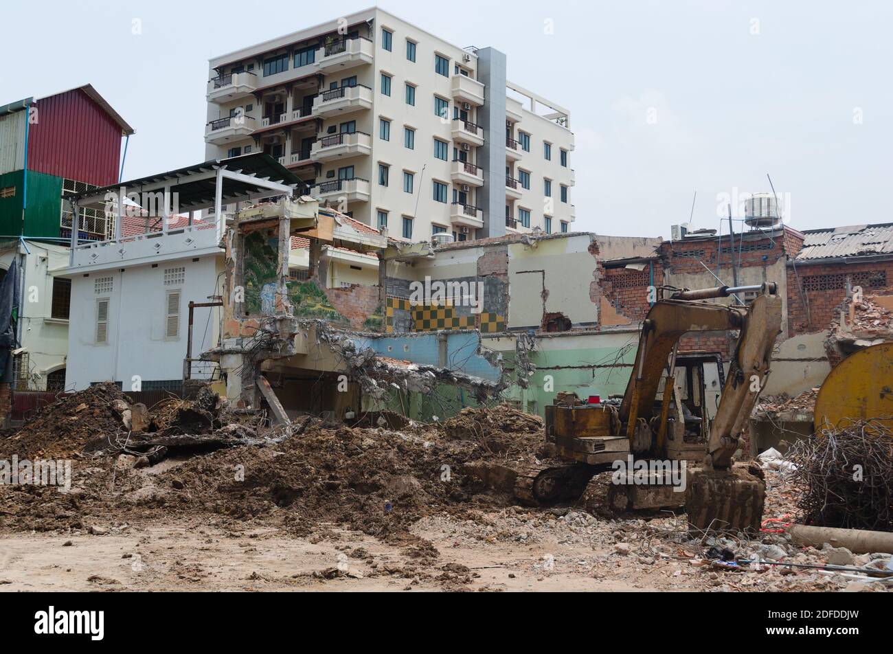 Demolished old house. Excavator crashed at demolition construction site ...