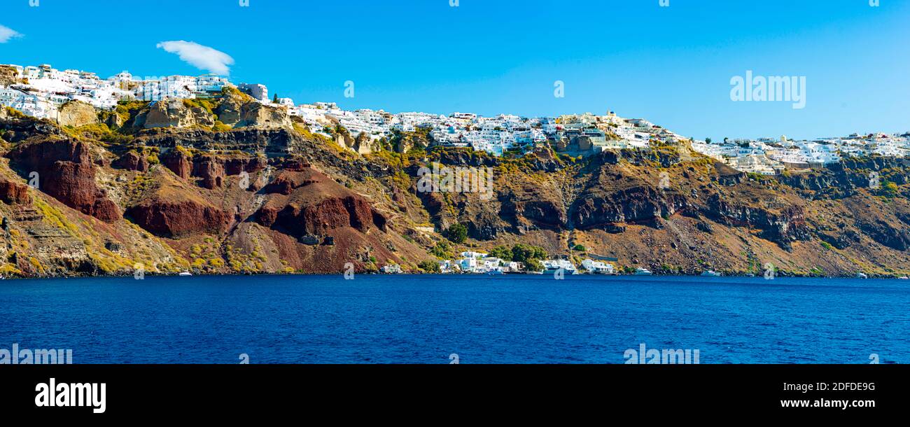 Handheld view of the coastal cliffs of Santorini as seen from a boat on ...