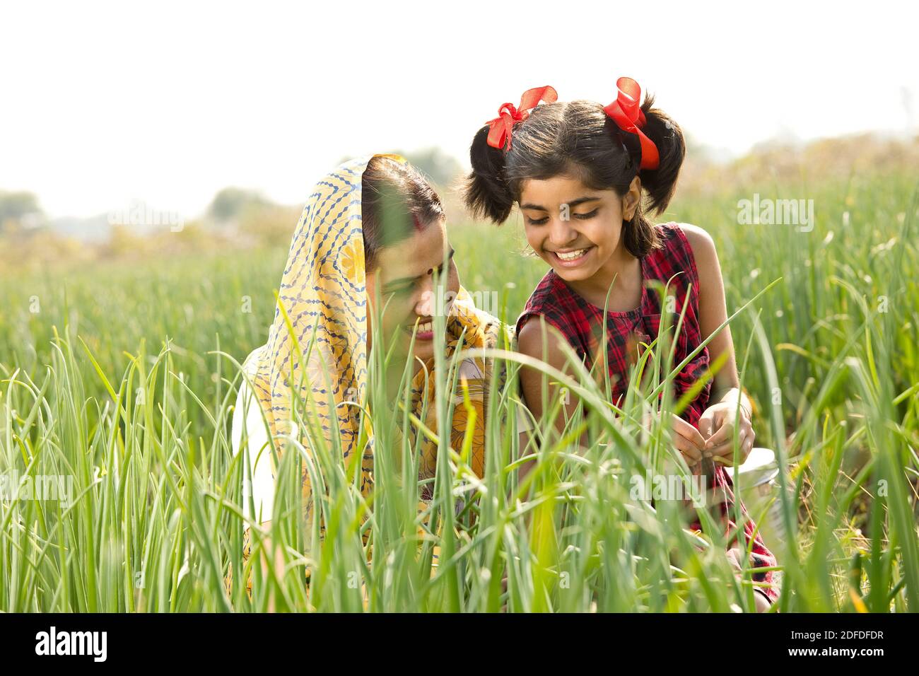 Rural mother with daughter in agricultural field Stock Photo - Alamy