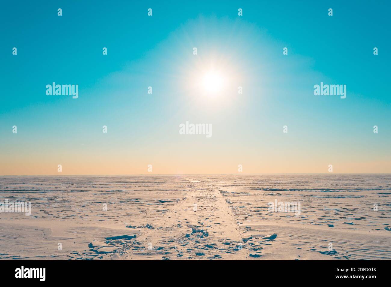 Road in the snow in the winter snowy desert in the turquoise sky the ...