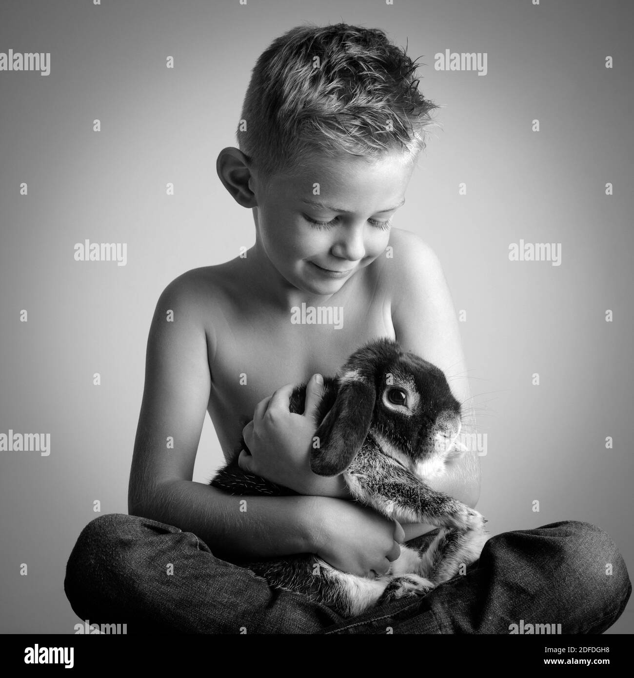 A BOY AND HIS RABBIT, CHILD AND PET, STUDIO PORTRAIT Stock Photo - Alamy