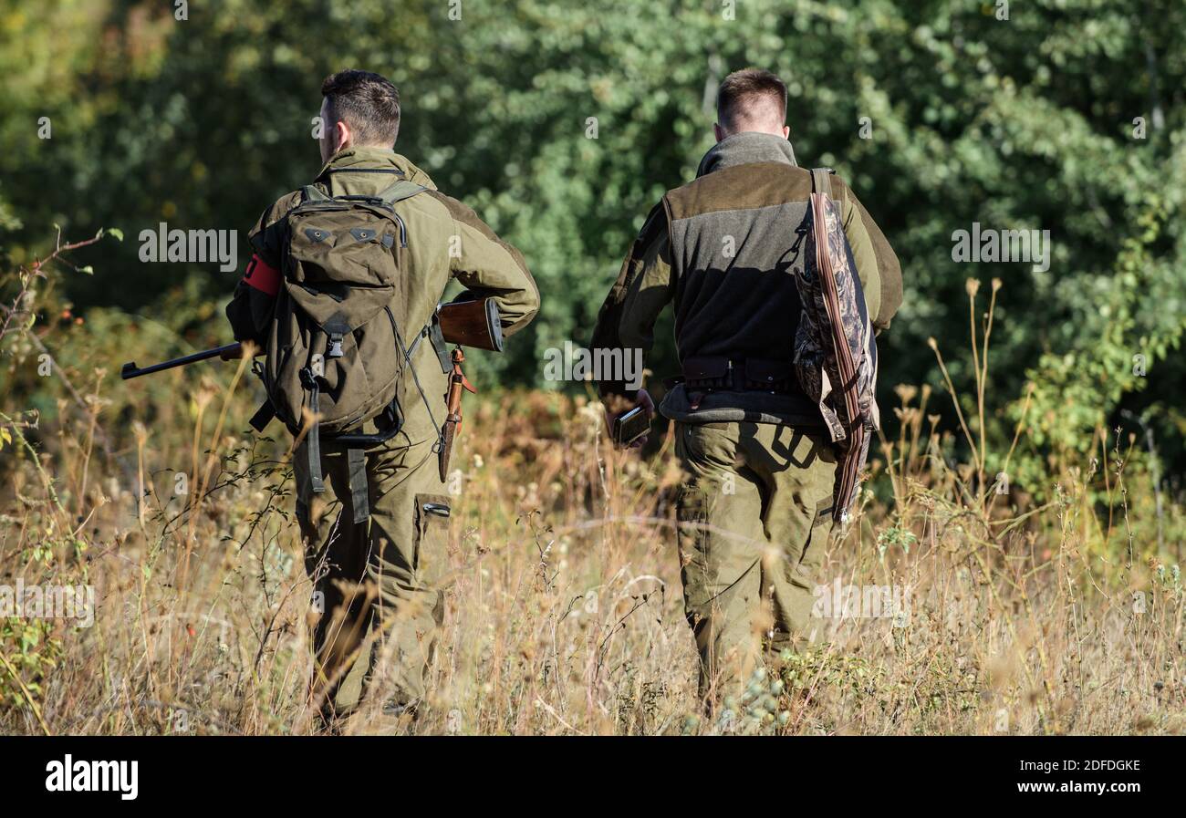 Man hunters with rifle gun. Boot camp. Military uniform. Friendship of ...