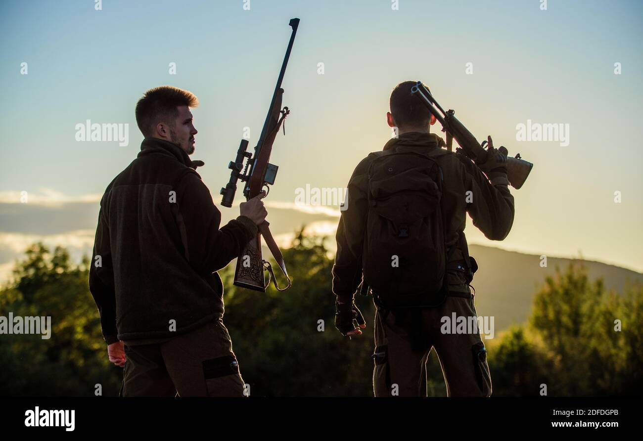 Hunters friends gamekeepers with guns silhouette sky background ...