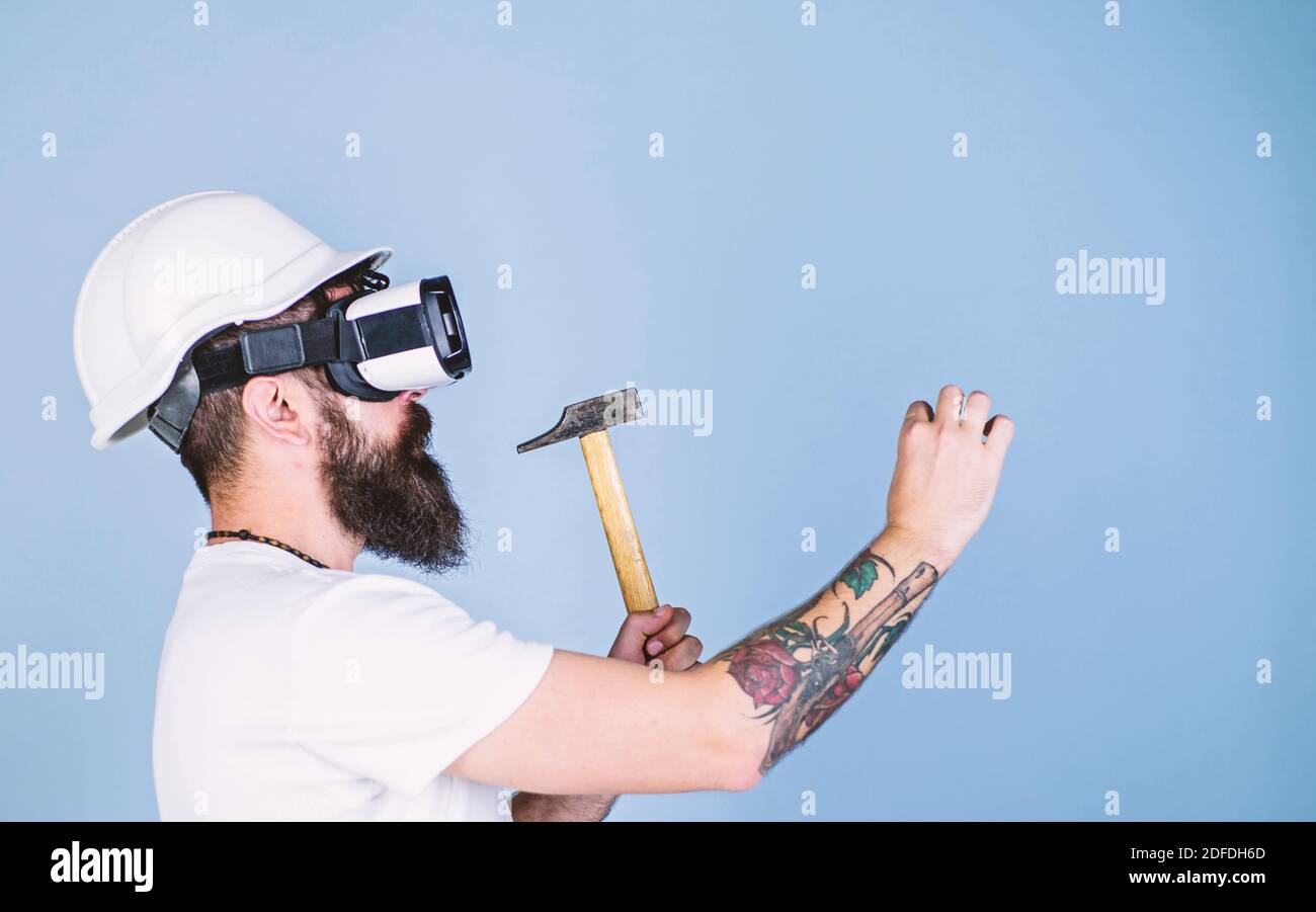 Builder and renovation concept. Man with beard in VR glasses holds ...