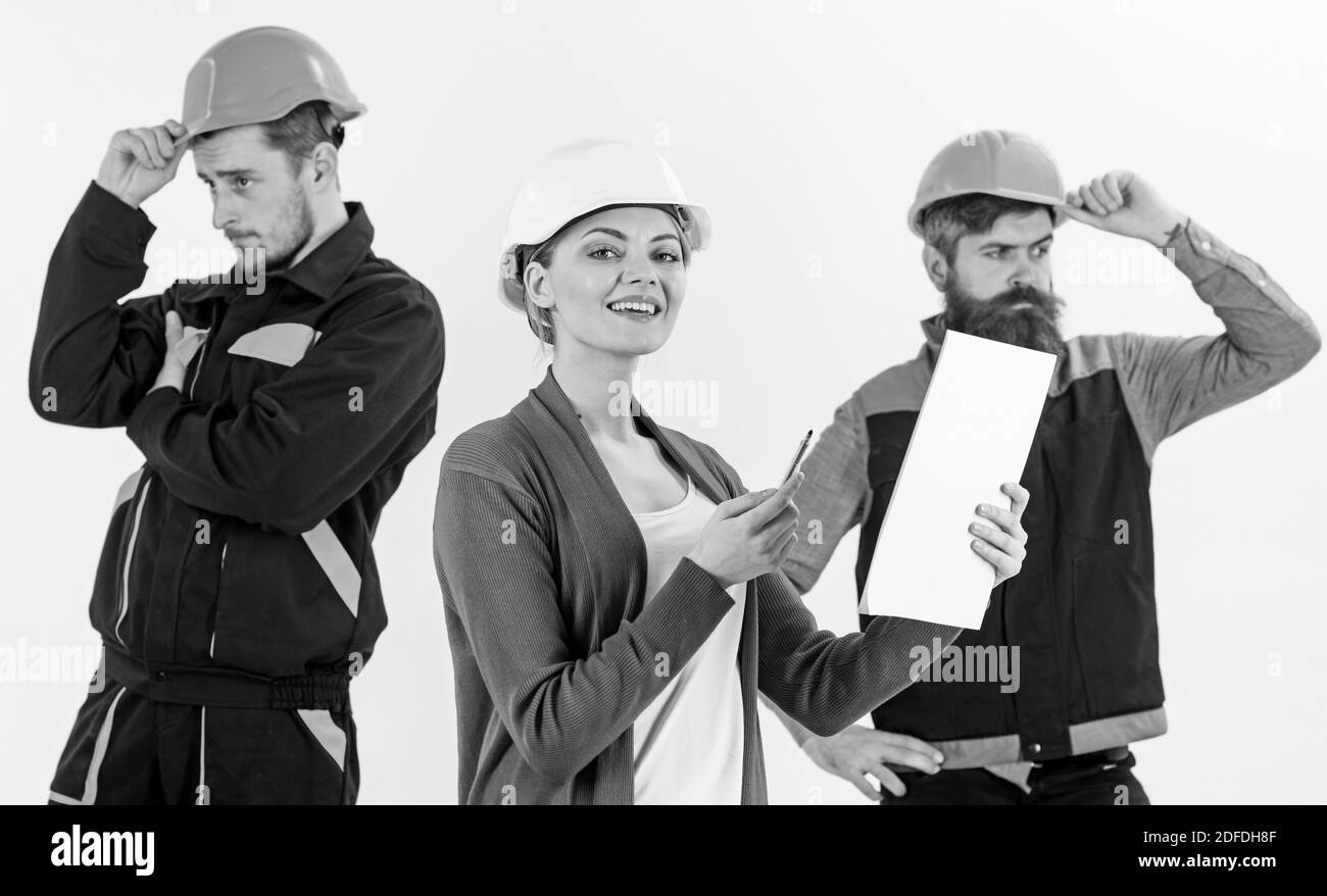 Team of architects, builders with woman manager, boss looks at document ...