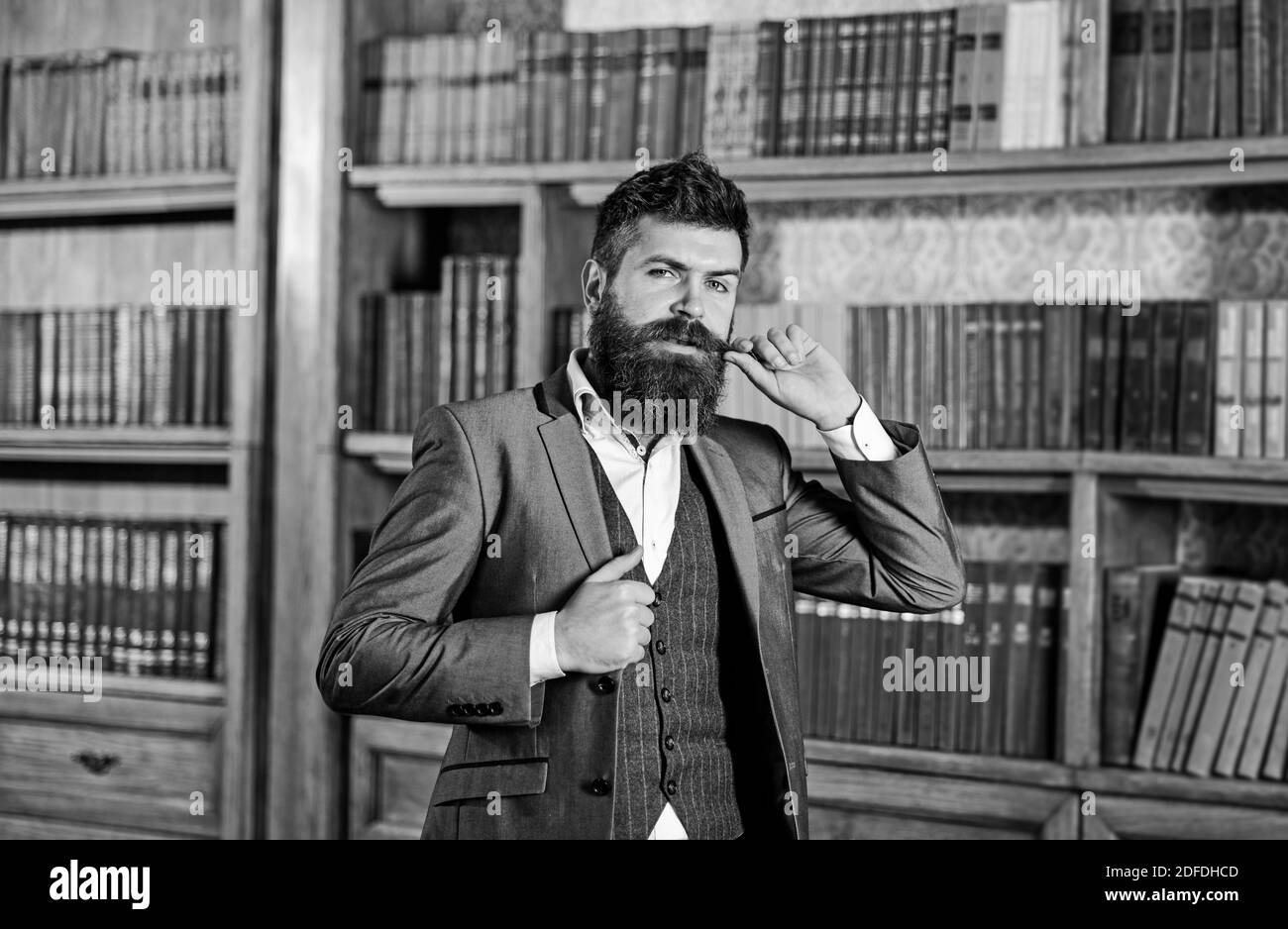 Senior man with long beard standing in a vintage library Stock Photo ...