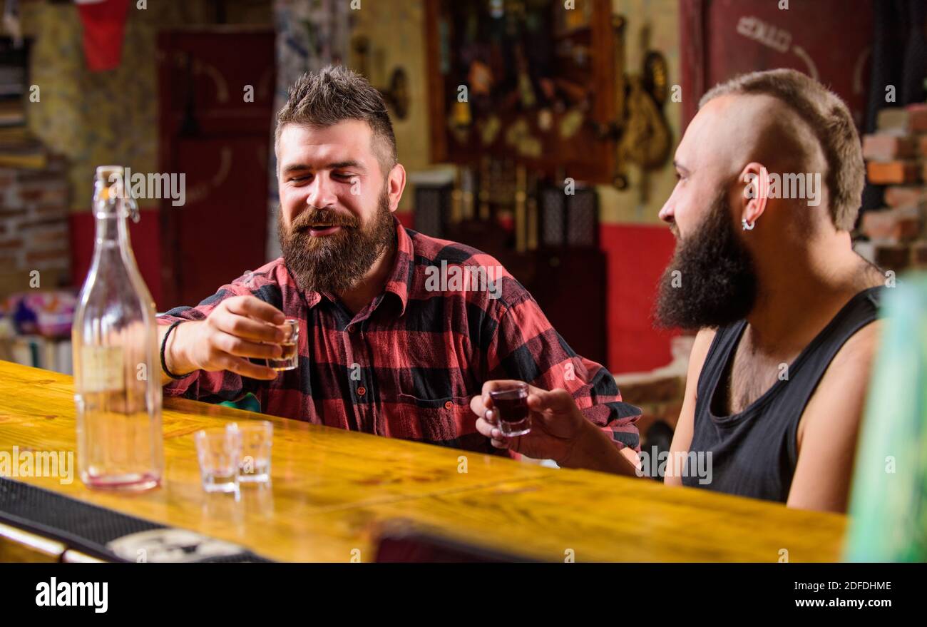 Friends relaxing in pub. Men drinking alcohol together. Alcohol ...