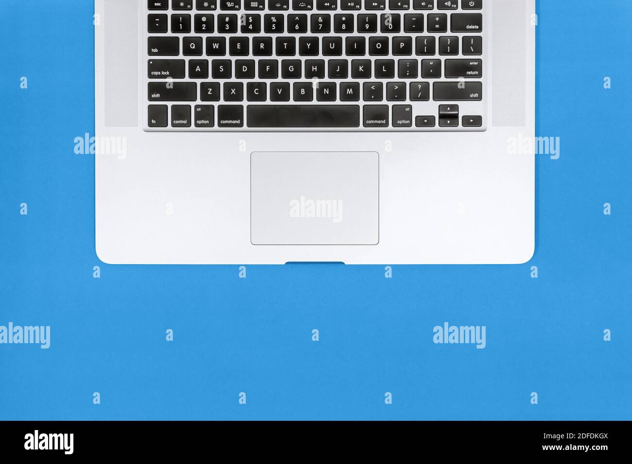 Close Up Overhead of Laptop Keyboard on Blue Background Stock Photo - Alamy