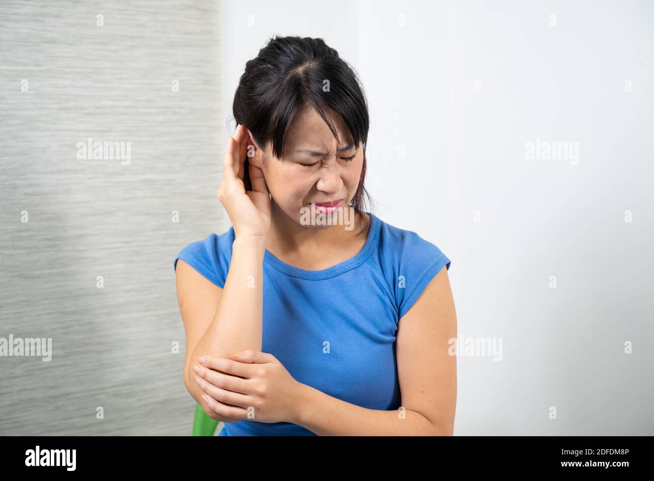Asian woman having earache Stock Photo - Alamy