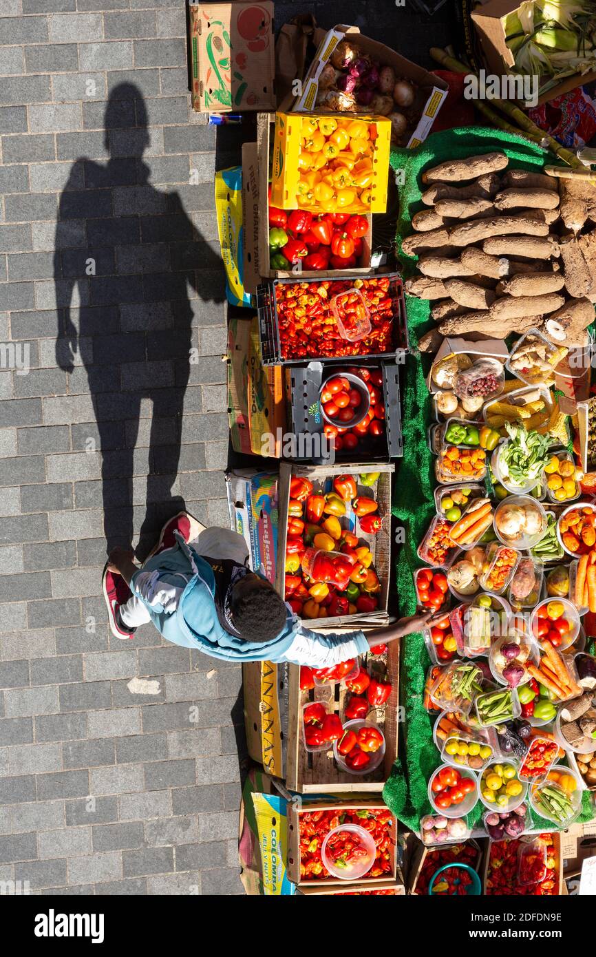 View from above of a person shopping at a street stall at Brixton ...