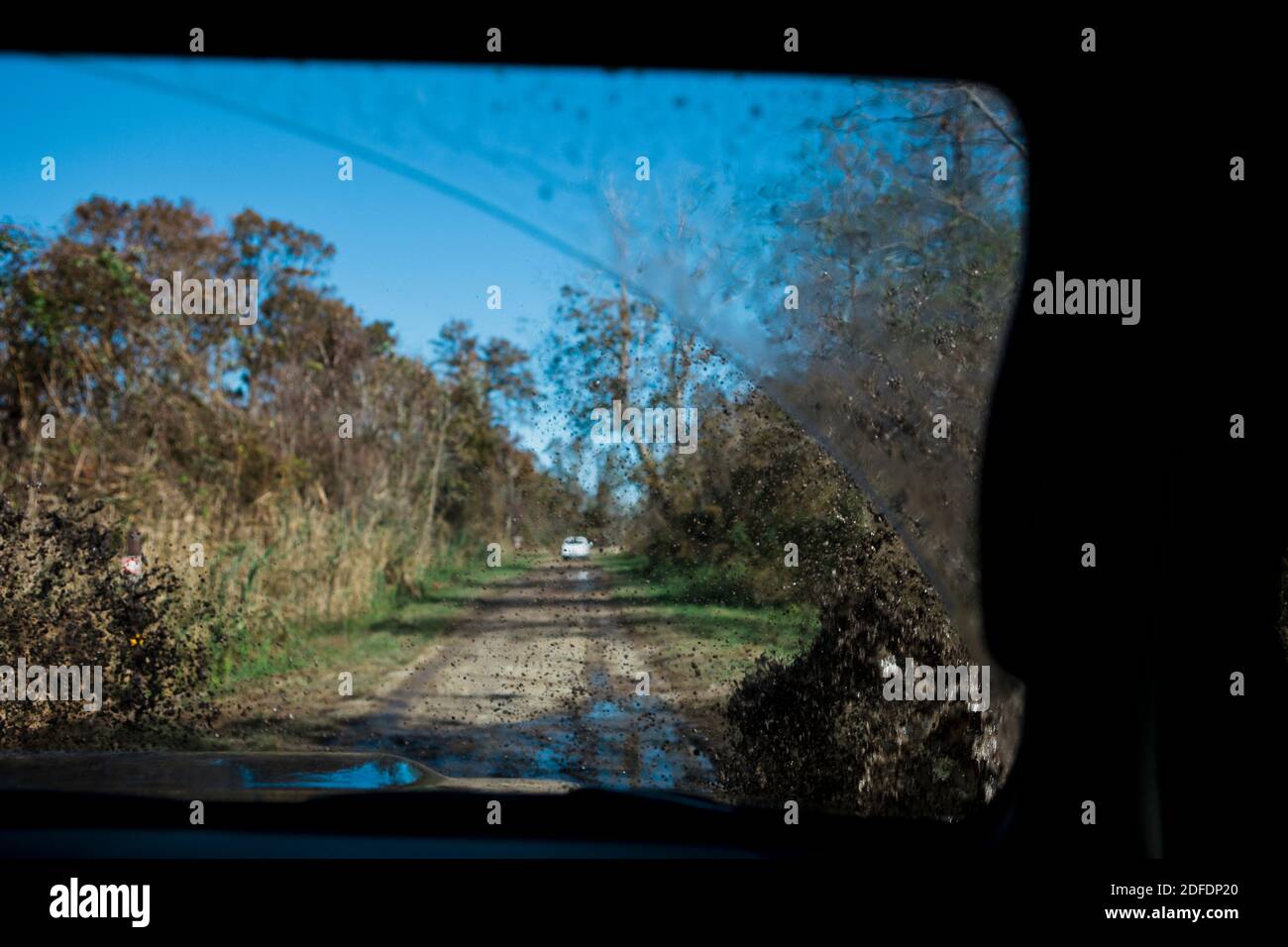Driving through mud as it splatters on the windshield Stock Photo - Alamy