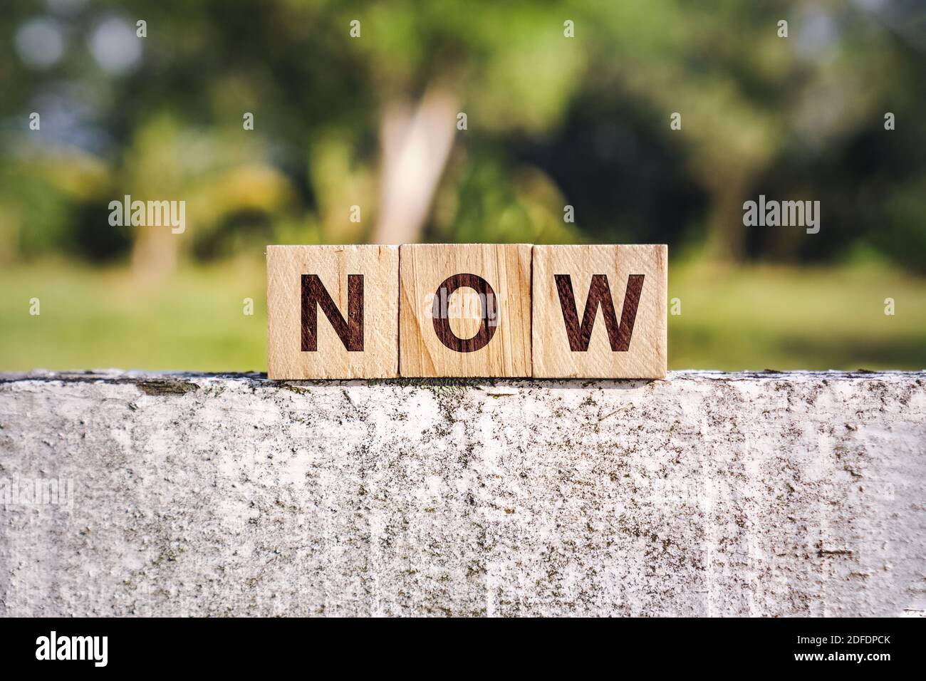 Wooden Block With The Word Now Stock Photo - Alamy