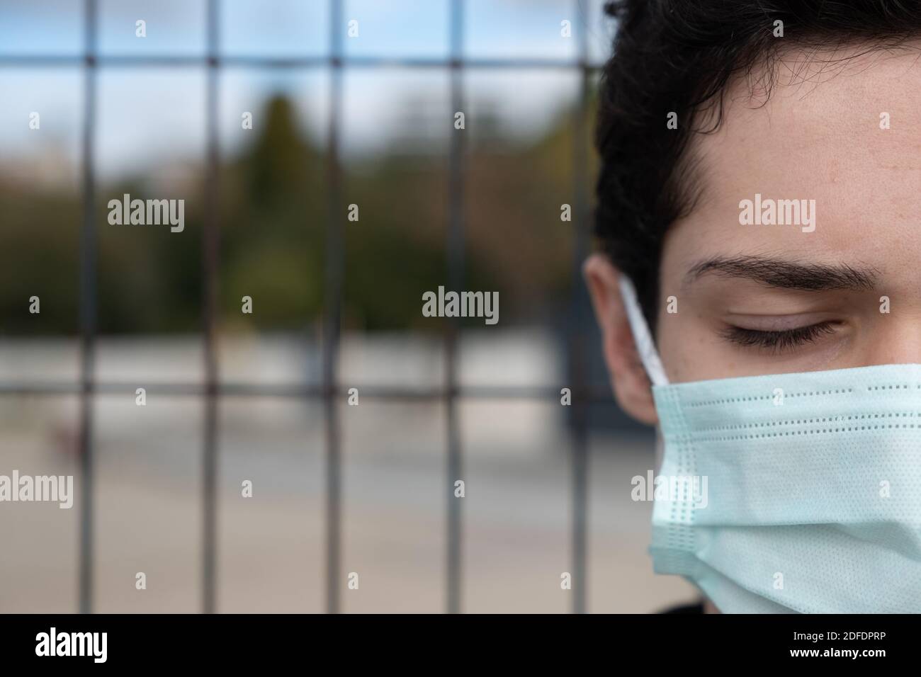 Portrait of a teenager wearing a mask half face Stock Photo - Alamy