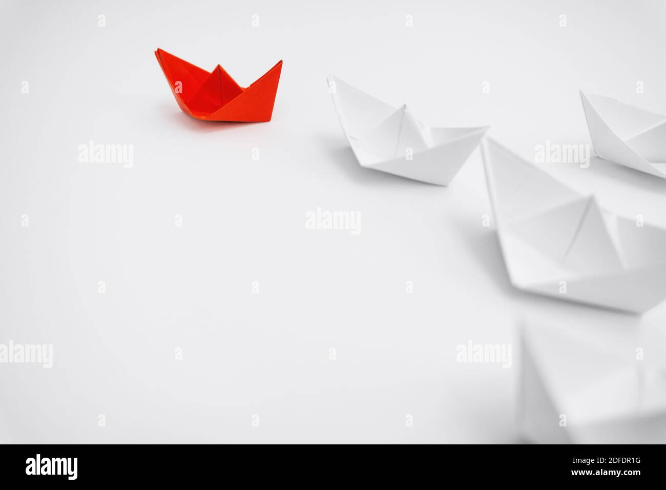 Business and Leadership. Unique Paper Boat Leading The Rest By Example ...