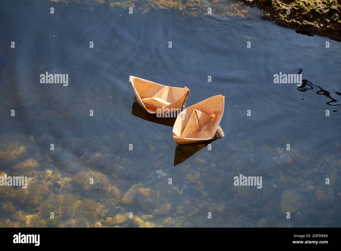 Two paper boats in the water Stock Photo - Alamy