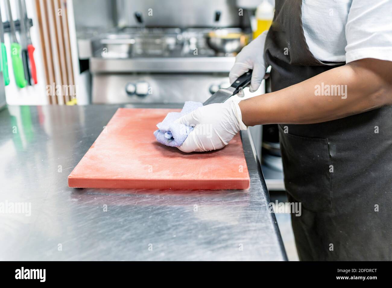 cook cleaning knives after cooking Stock Photo - Alamy
