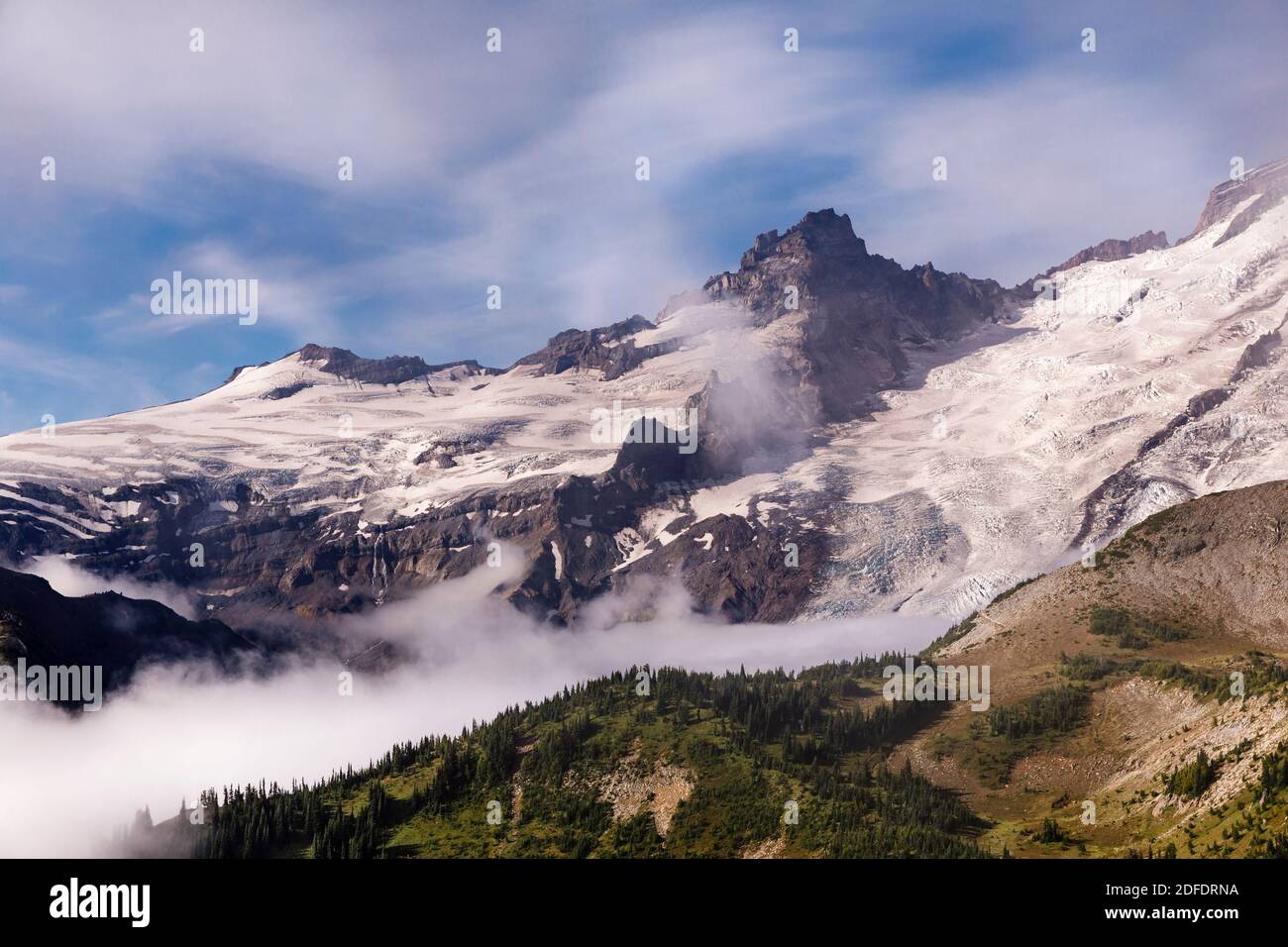 Snow and clouds accentuate the mountain textures of crevices and peaks ...