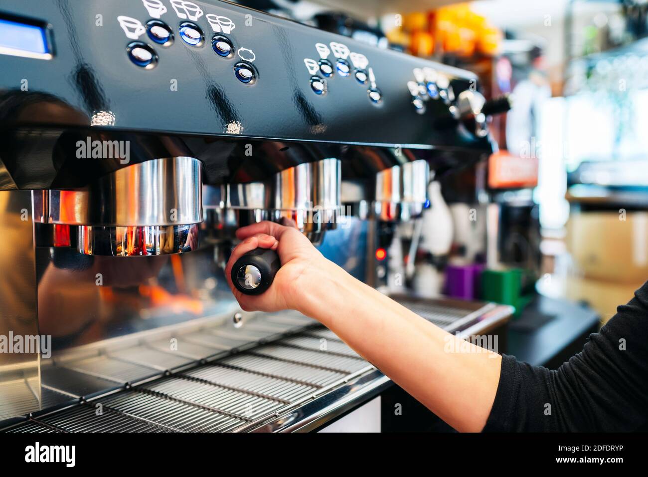 woman's hand making coffee in professional coffee maker Stock Photo - Alamy