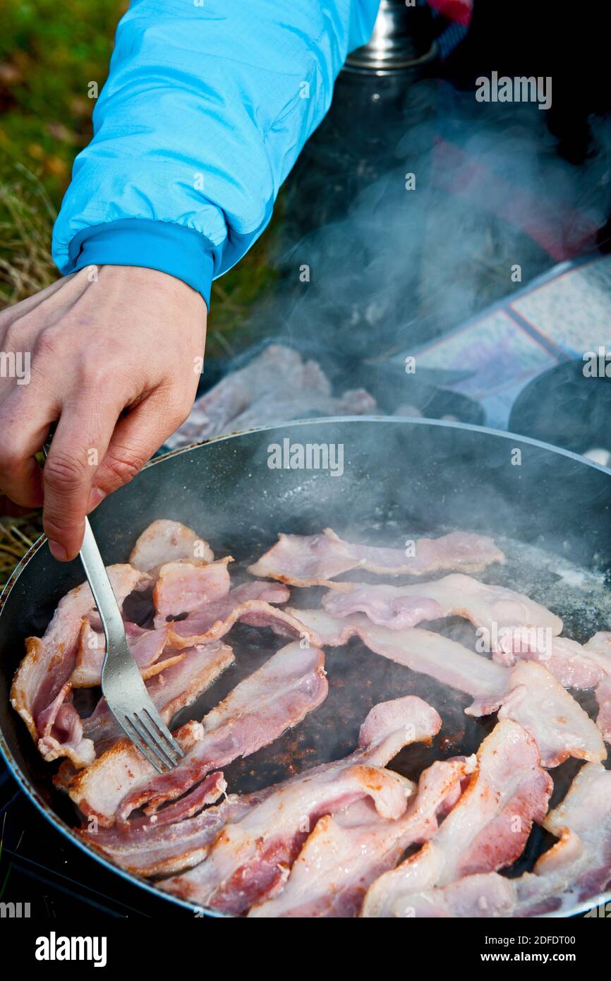 Woman frying bacon hi-res stock photography and images - Alamy