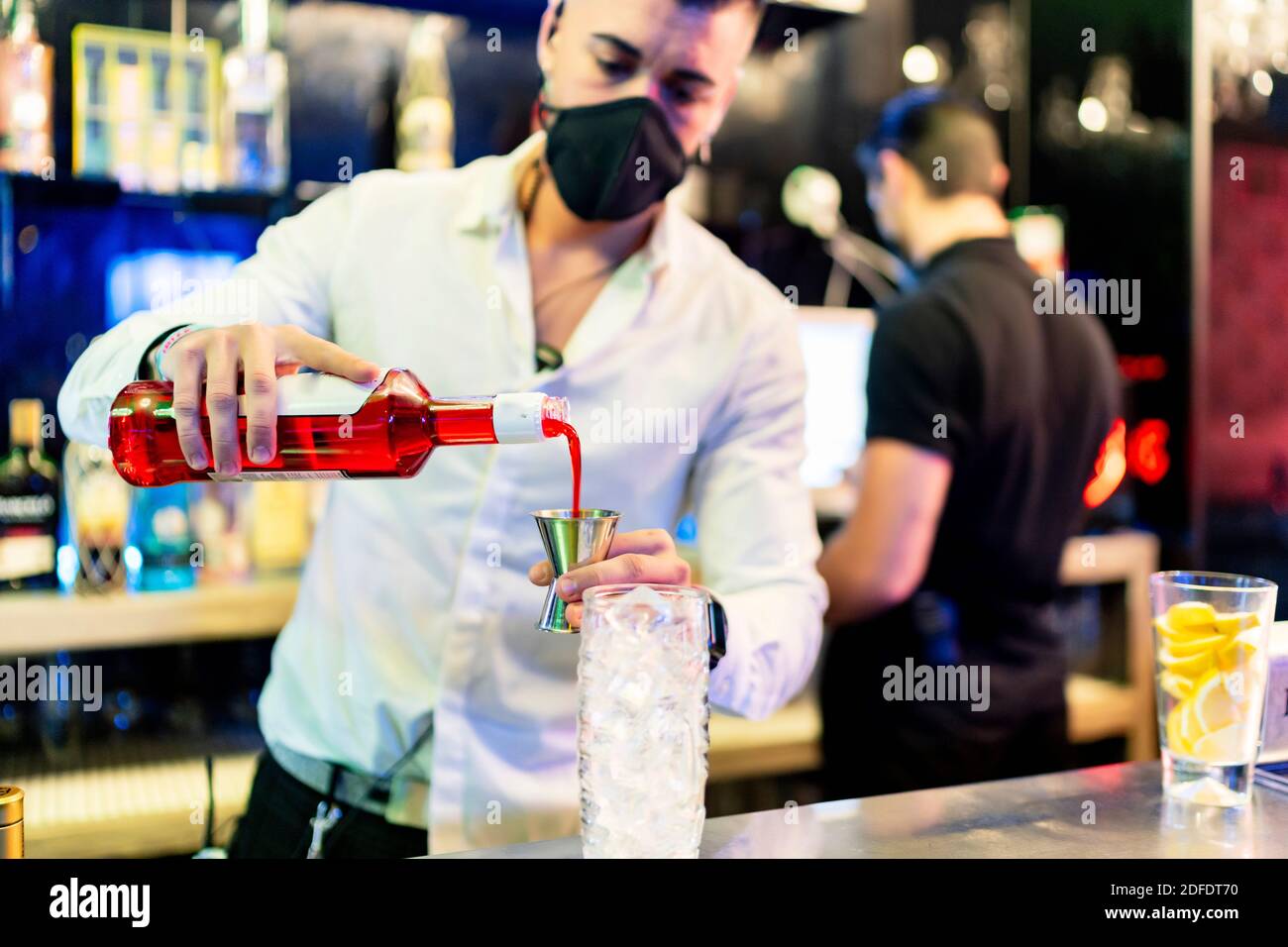 Bartender adding ingredient in shaker hi-res stock photography and ...