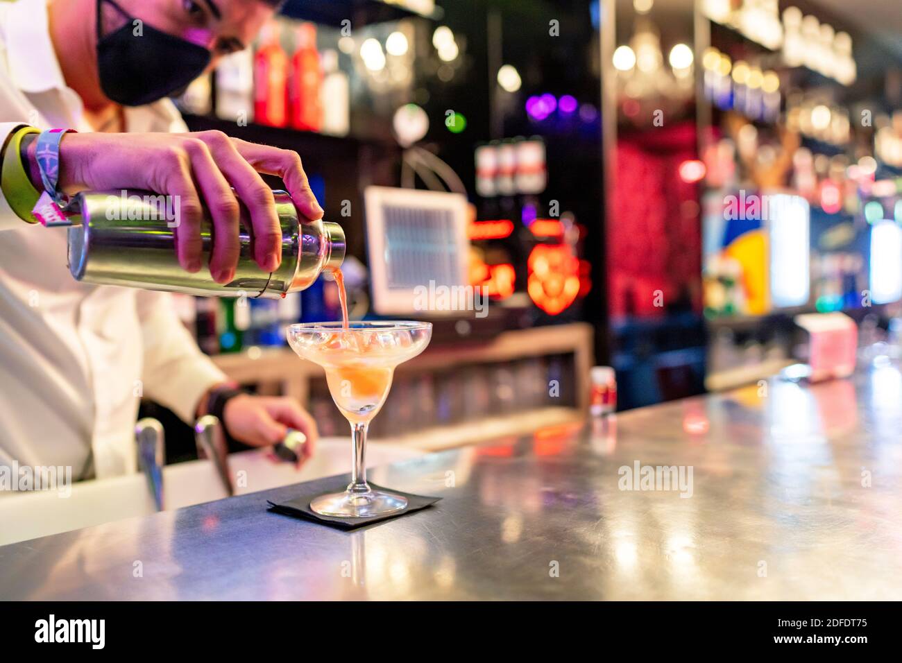 waiter serving a cocktail in his bar Stock Photo - Alamy