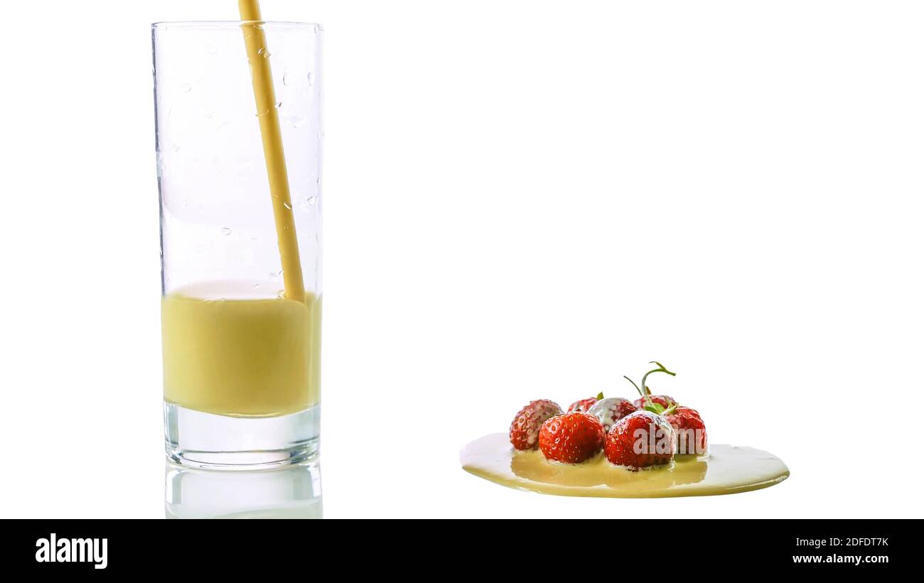 Pour yogurt into a glass close-up,fresh strawberry with yogurt isolated ...