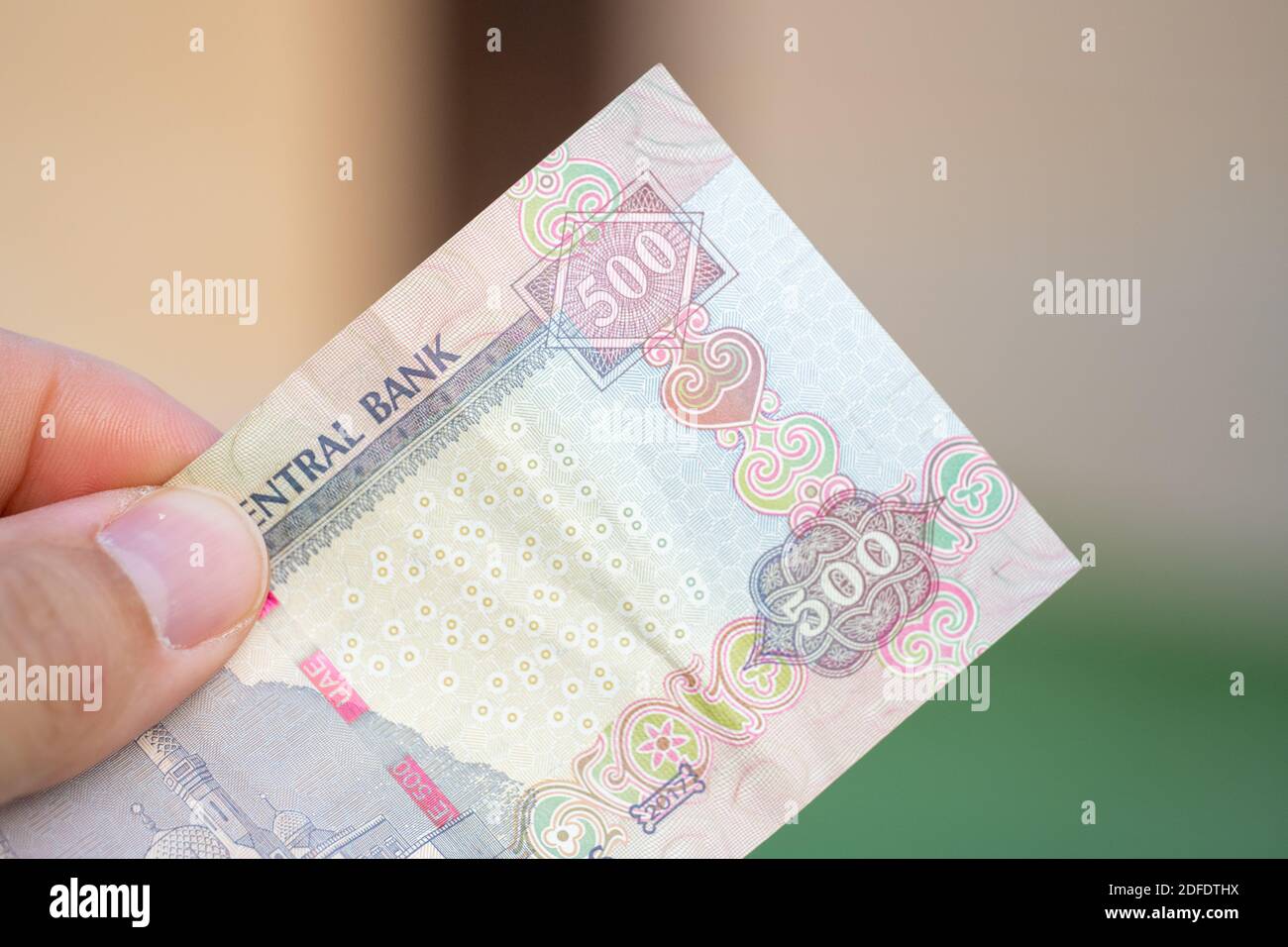 Hand holding Currency of the United Arab Emirates (UAE) - Close up of a ...