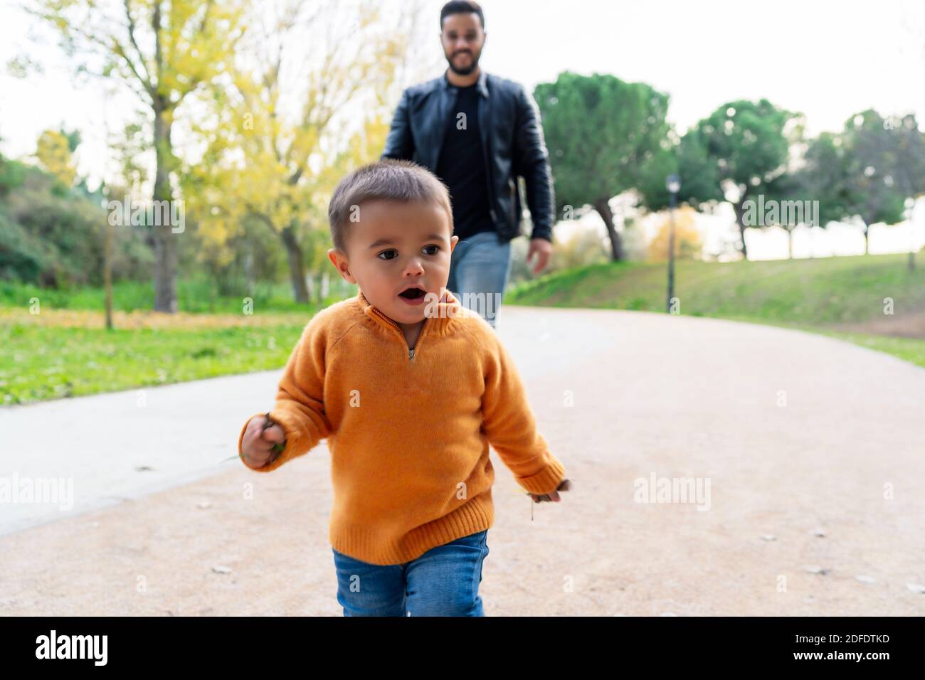 little boy running with his father Stock Photo - Alamy
