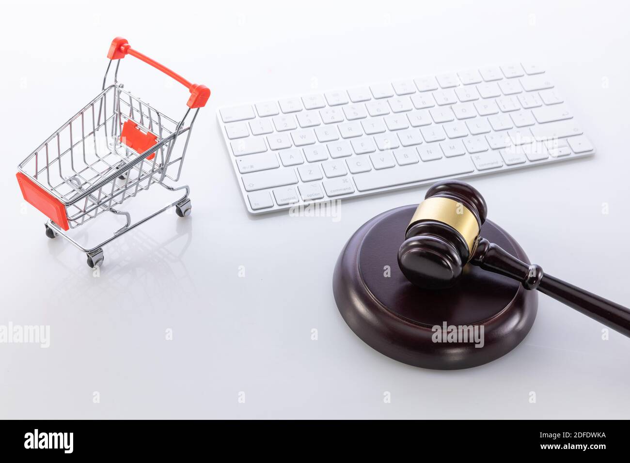 A gavel, keyboard, and miniature trolley on a white background - law concept Stock Photo - Alamy