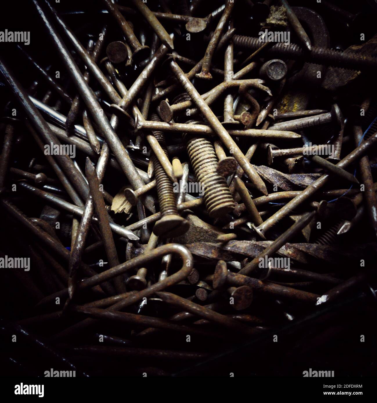 A pile of various rusty bolts, nuts, and washers for an abstract ...