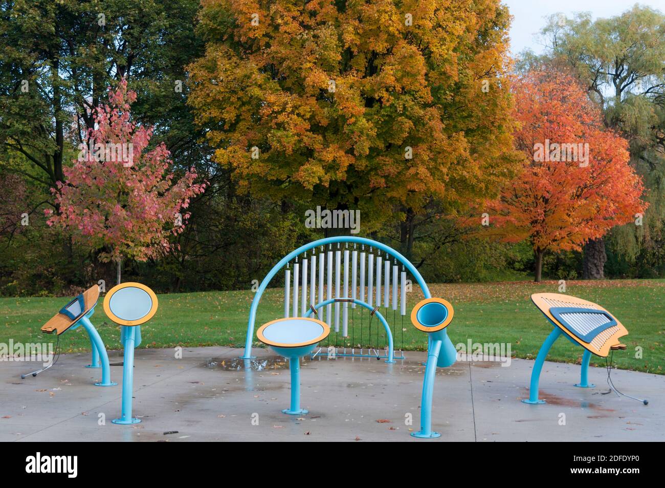 Children's musical instruments in a park, Ontario, Canada. Maple trees ...