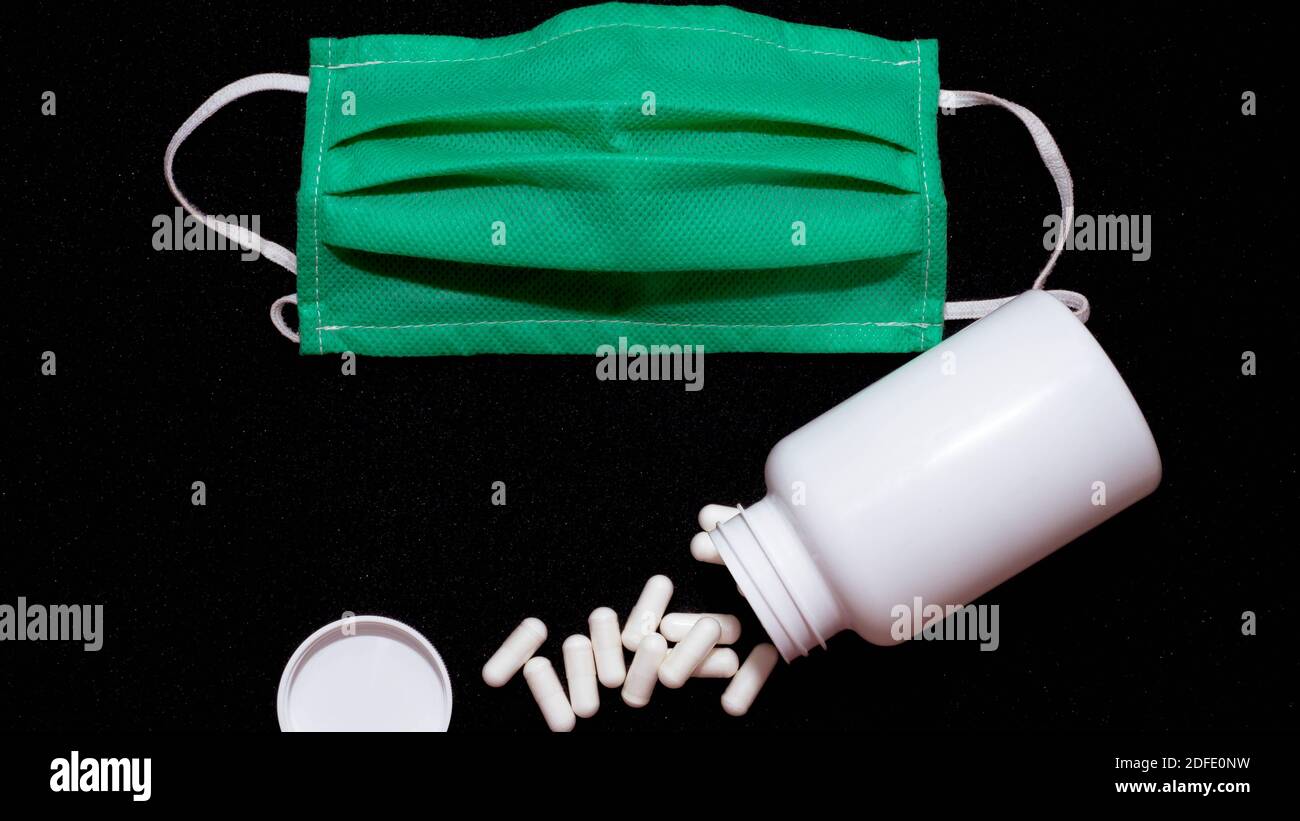 Medical mask on a black background,a protective mask against viruses an ...