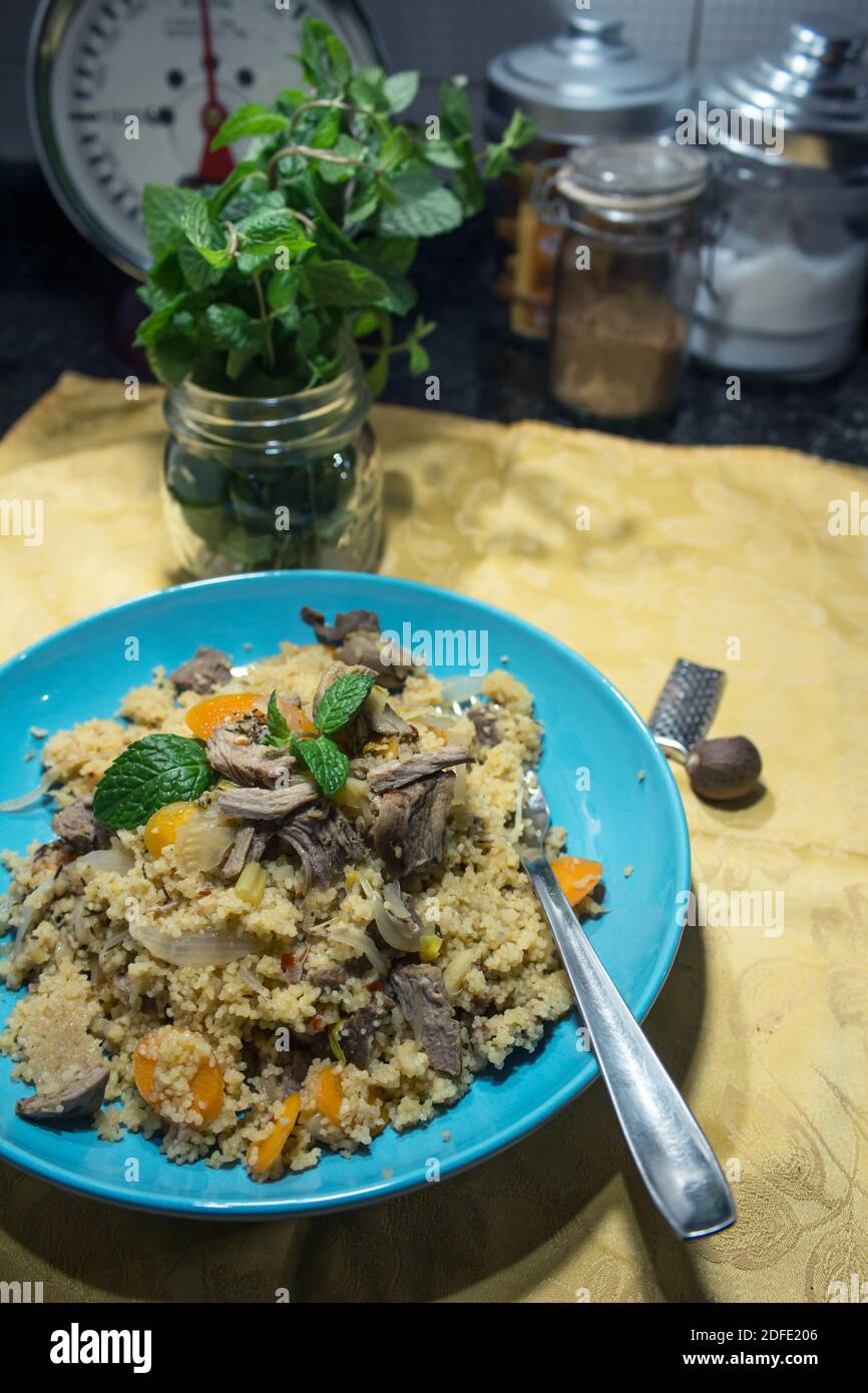 Couscous made from turkey meat and vegetables in a blue dish Stock ...