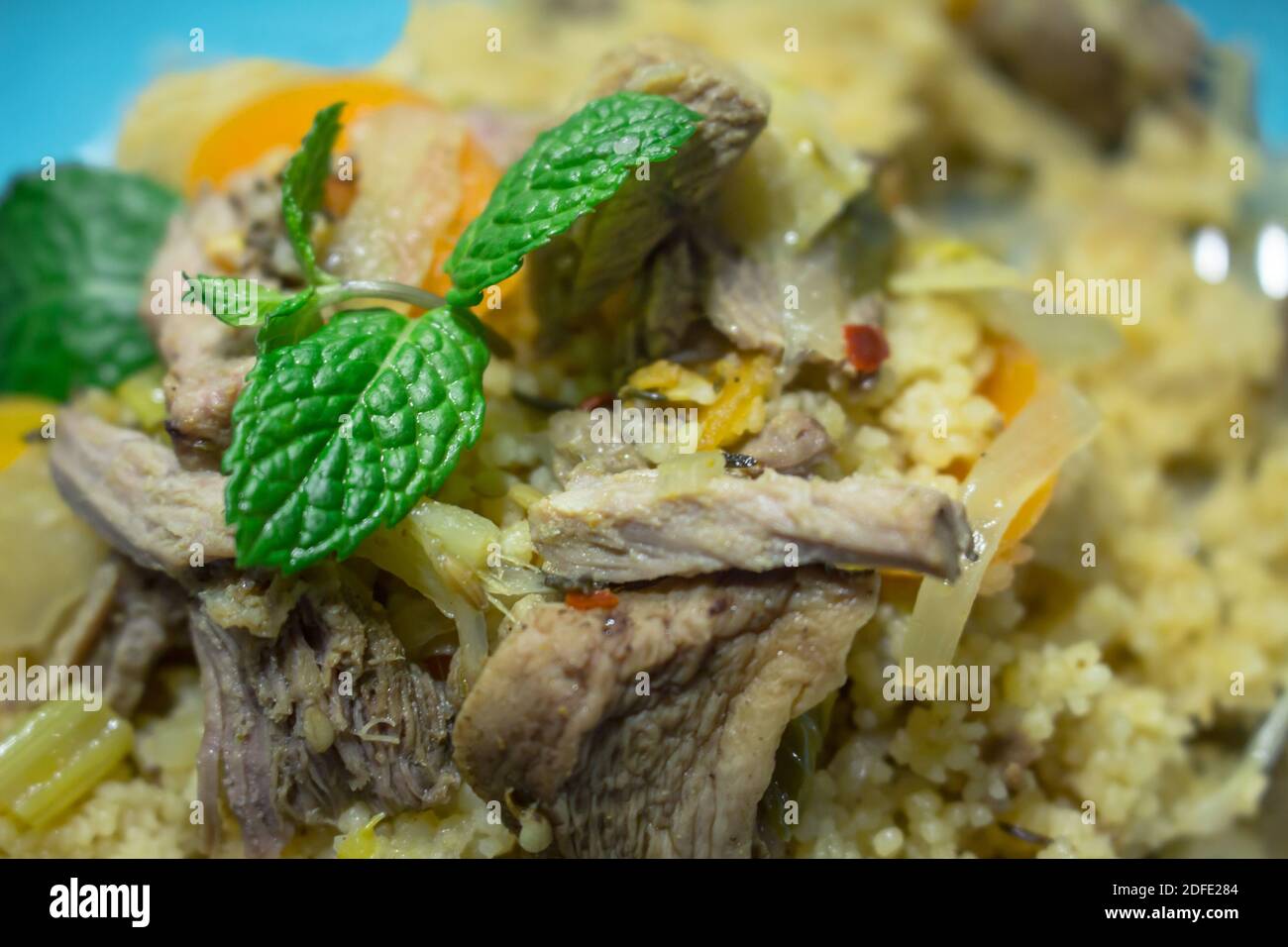 Couscous made from turkey meat and vegetables in a blue dish Stock ...