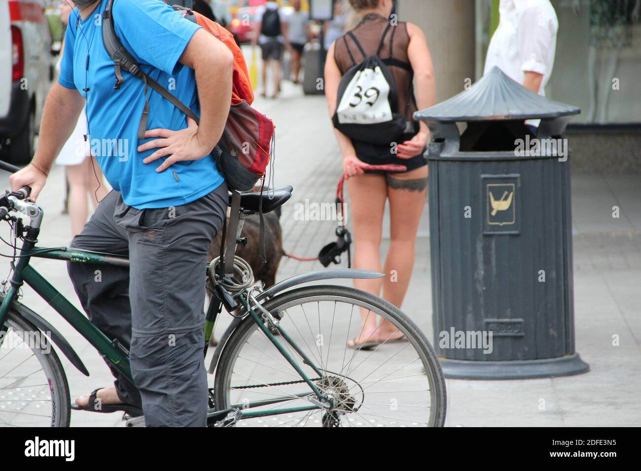 People walk and ride bicycles around city. Tourists ride around city on ...